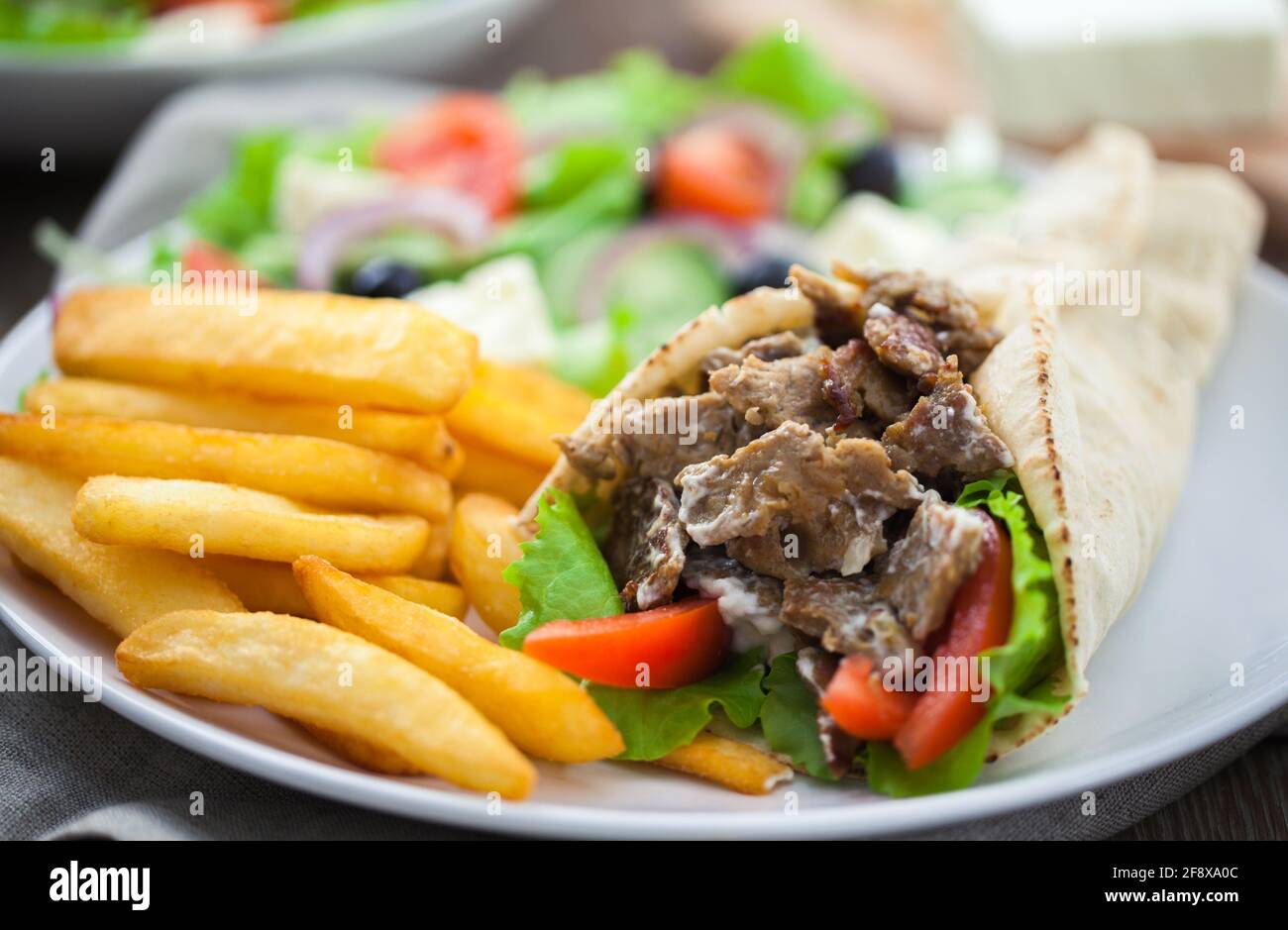 Greek Gyros with Fries and Salad on a Plate Stock Photo - Alamy