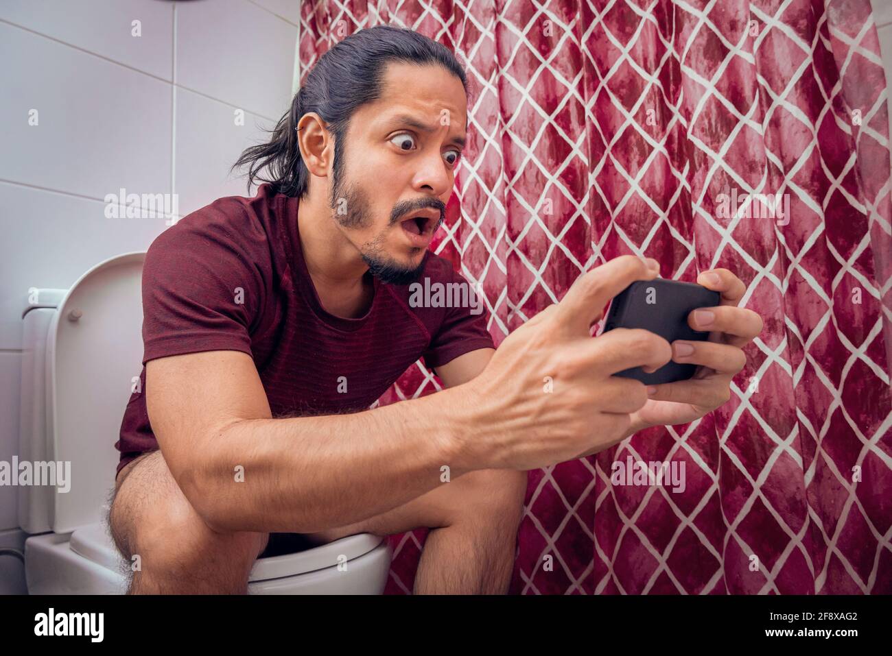 Black man on toilet on phone hi-res stock photography and images - Alamy