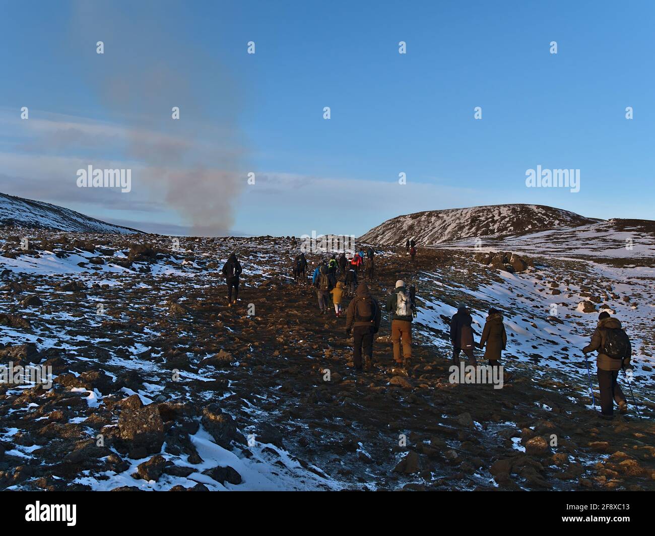 Group of people hiking to recently started volcanic eruption at ...