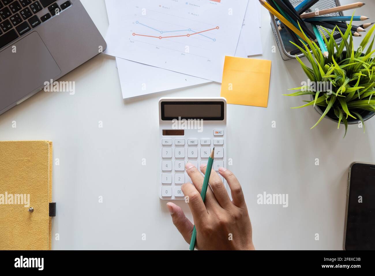 Top view hand of accountant using calculator on workplace with copy ...