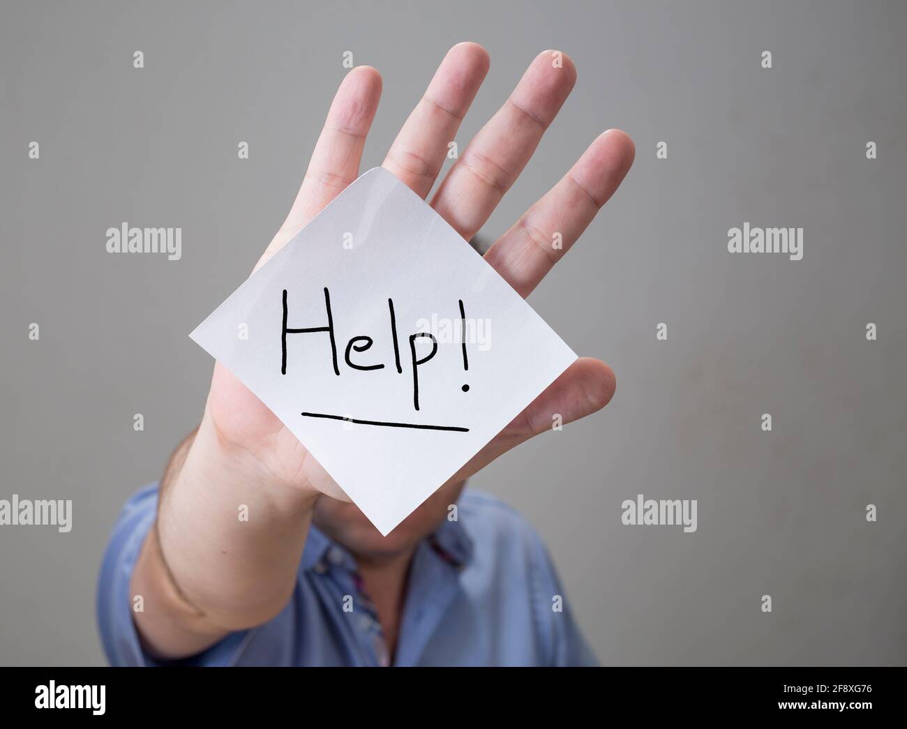 Man requesting help - Word help written on a paper Stock Photo - Alamy