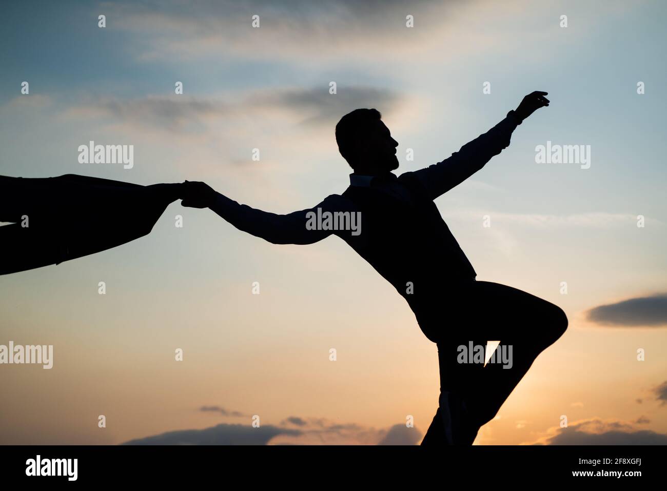 silhouette of man dancing in sense of freedom on sunrise sky, free ...