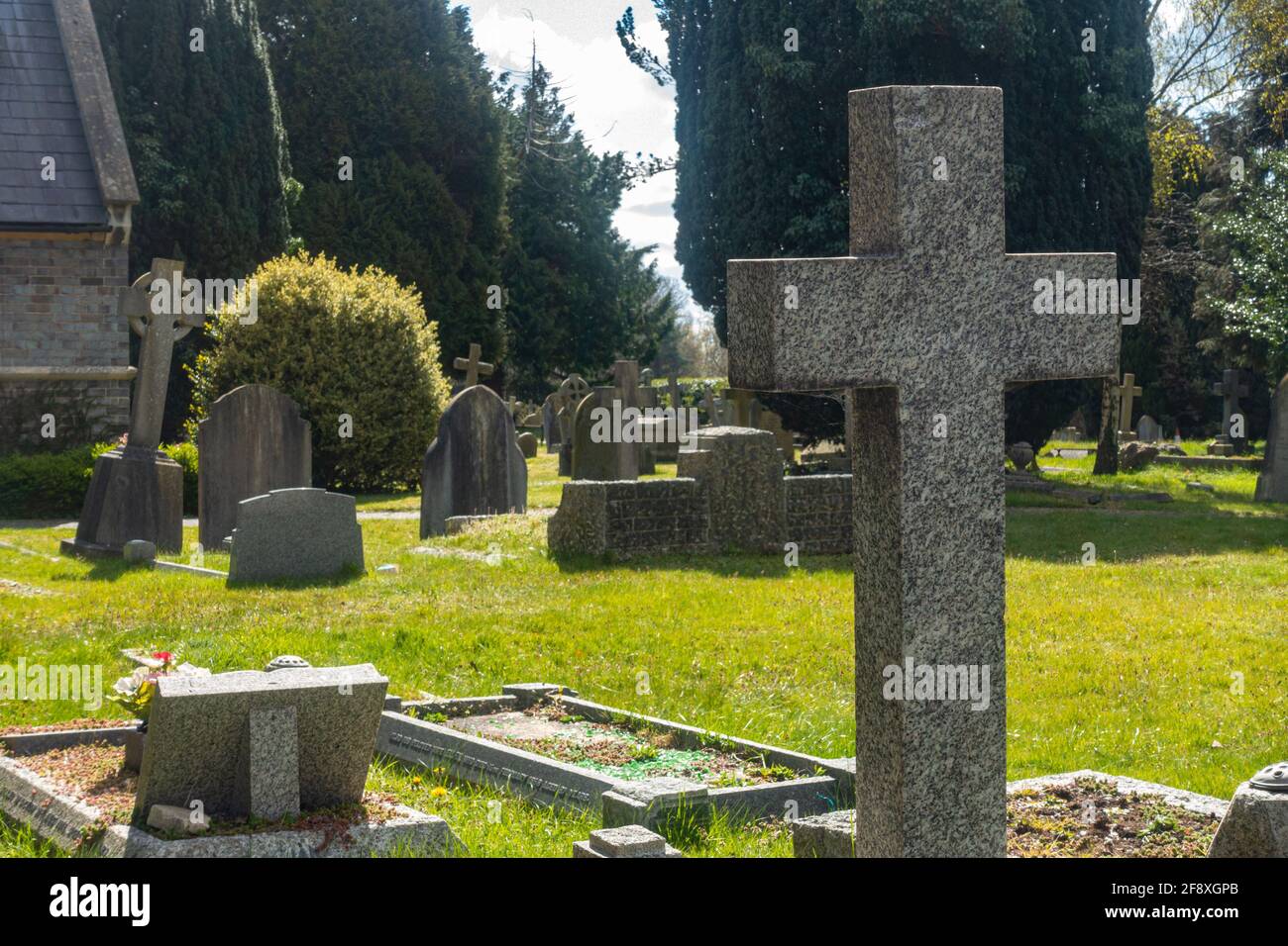 Gravestones stand in the church graveyard at Early St Peter's Church in ...