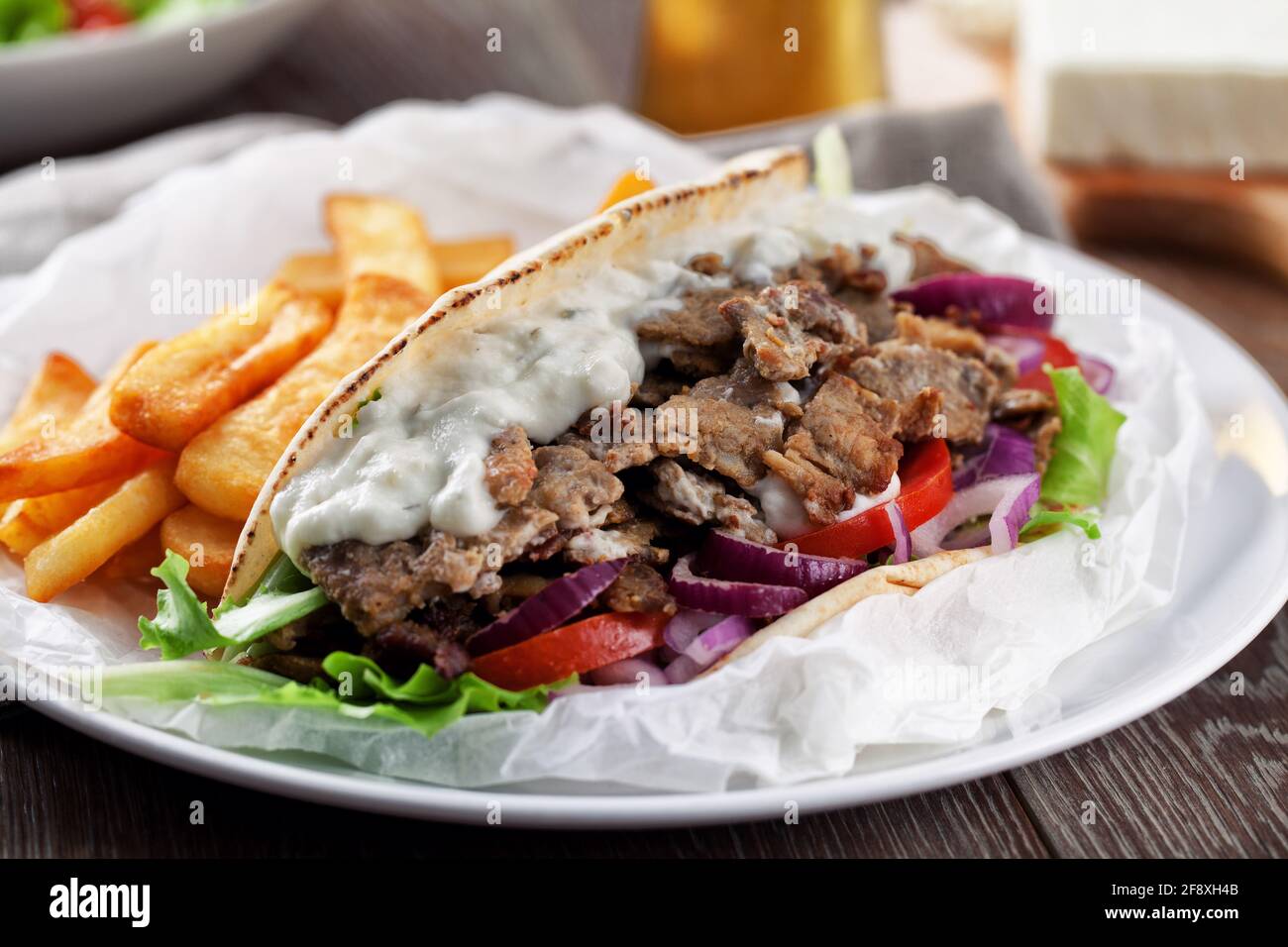 Greek Gyros with Fries and Salad on a Plate Stock Photo - Alamy