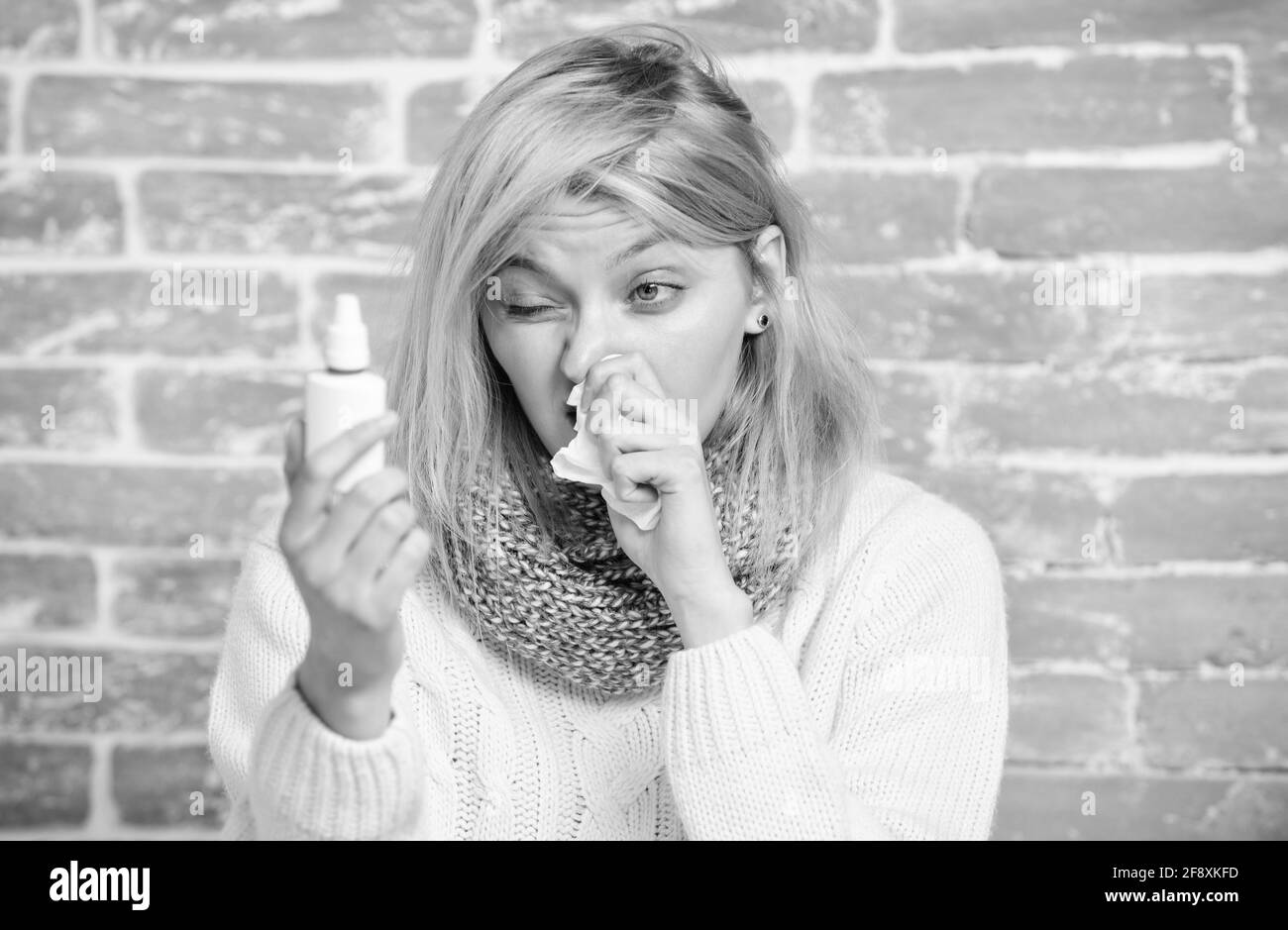 Clearing up the blockage. Pretty girl with runny nose holding nasal ...