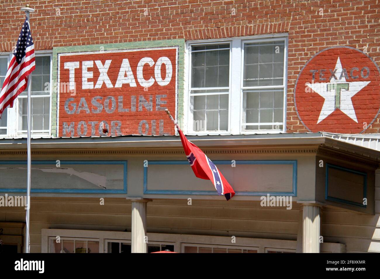 Old Texaco advertising signs painted on the outside wall of a business ...