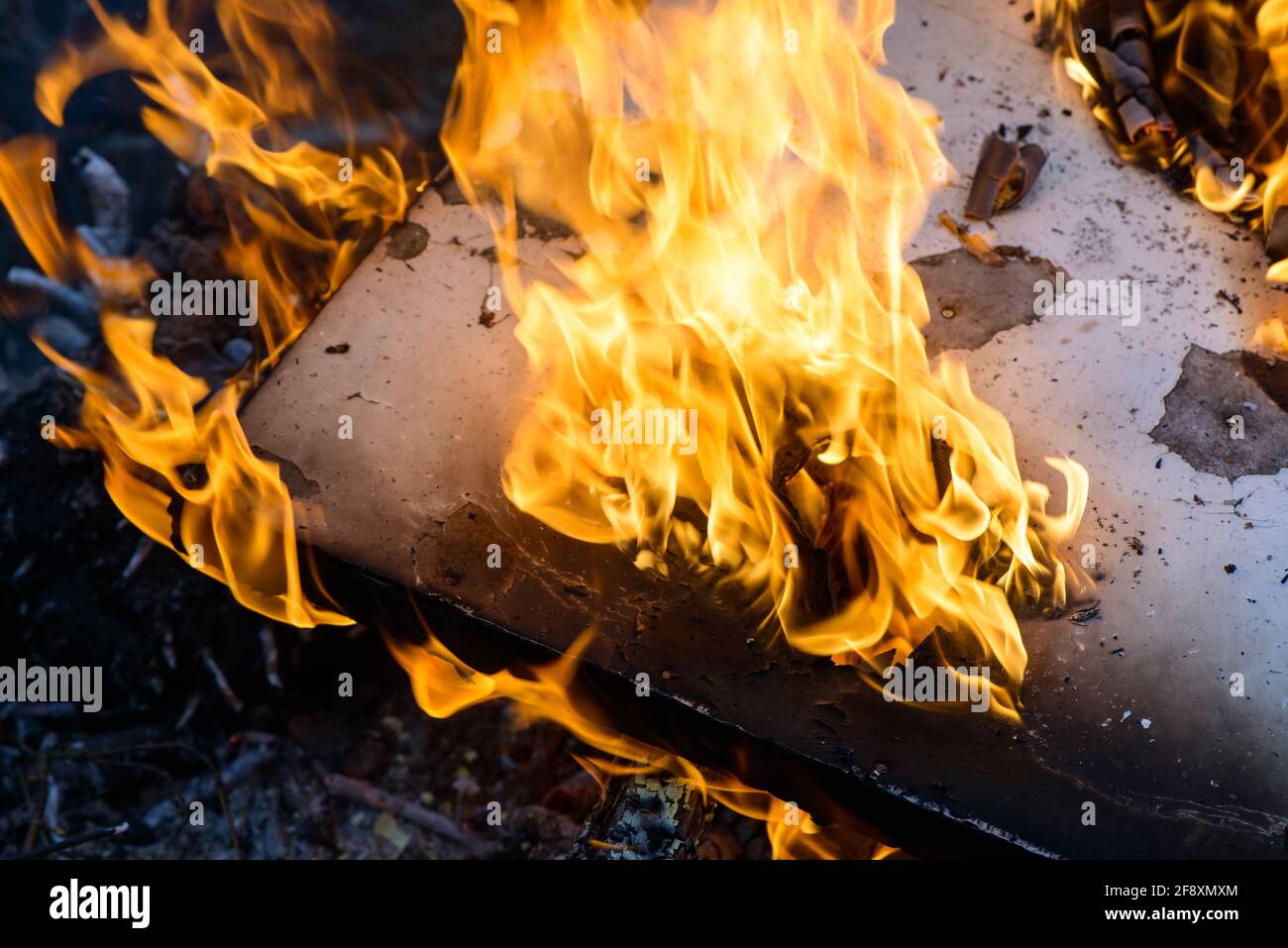 Spurts of flame. Burning wooden boards and logs. The bright flame of ...