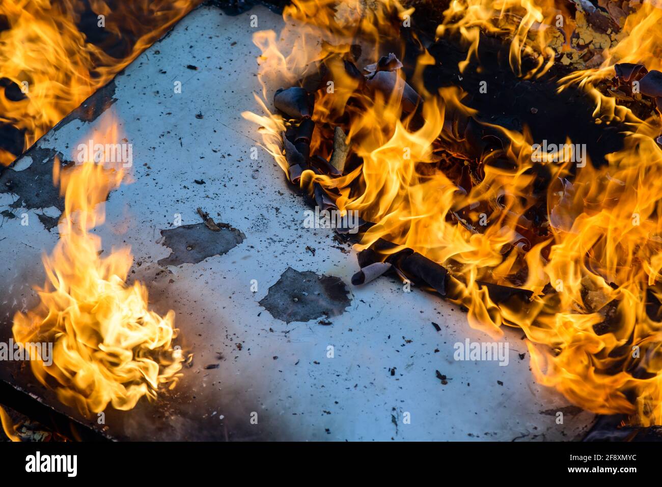 Spurts of flame. Burning wooden boards and logs. The bright flame of ...