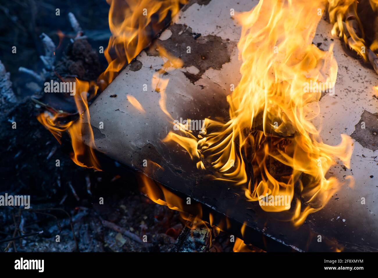 Spurts of flame. Burning wooden boards and logs. The bright flame of ...