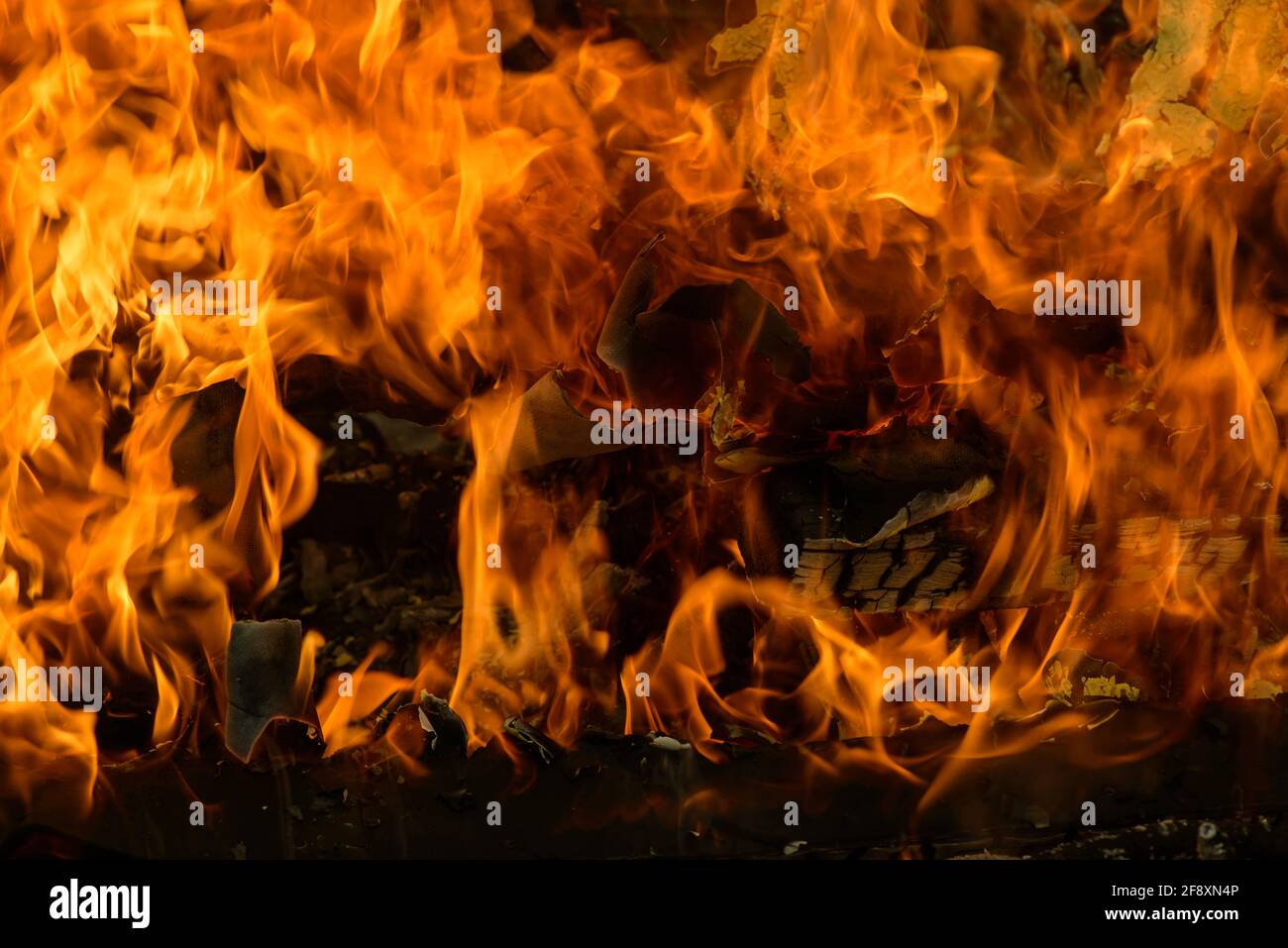 Spurts of flame. Burning wooden boards and logs. The bright flame of ...