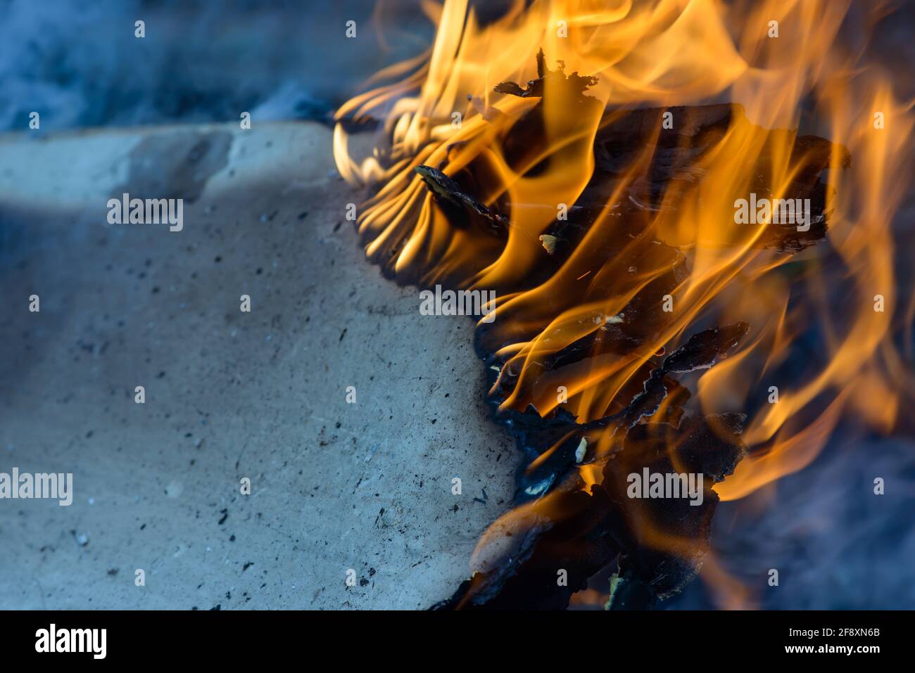 Spurts of flame. Burning wooden boards and logs. The bright flame of ...