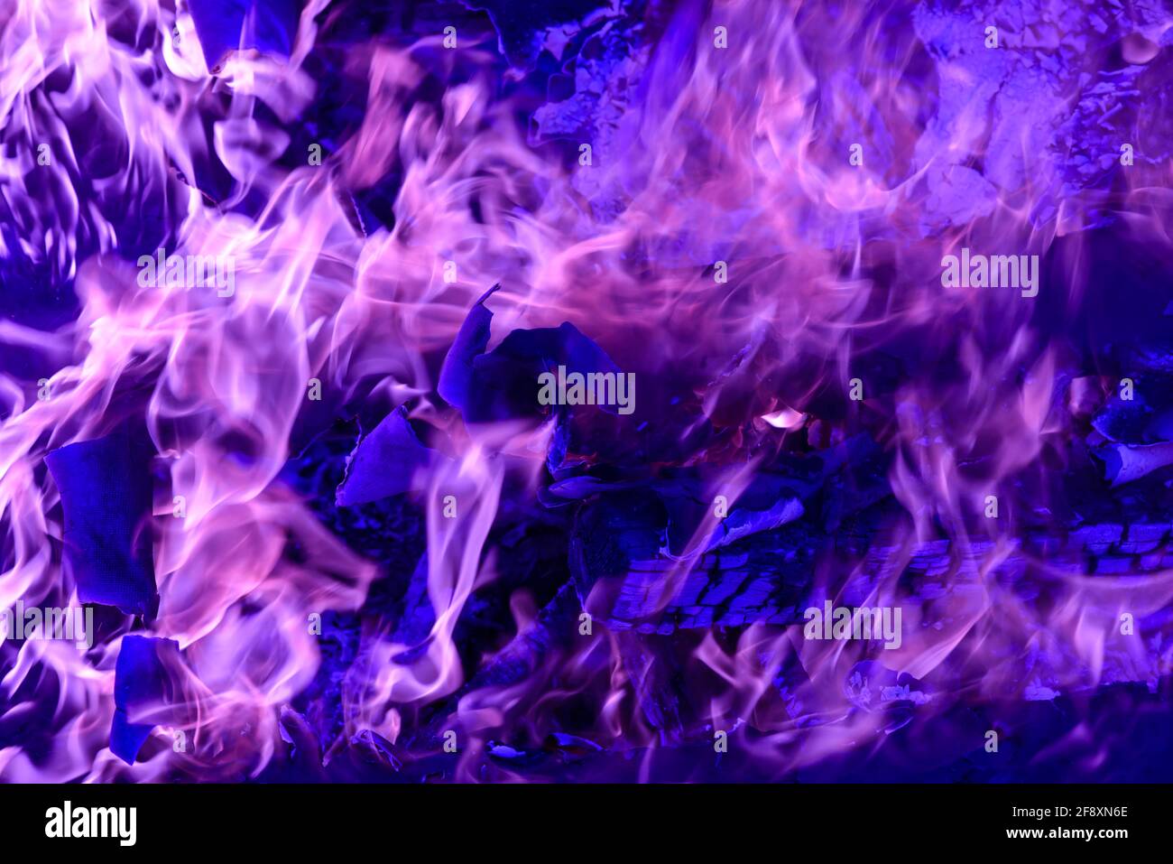 Spurts of flame. Burning wooden boards and logs. The bright flame of ...