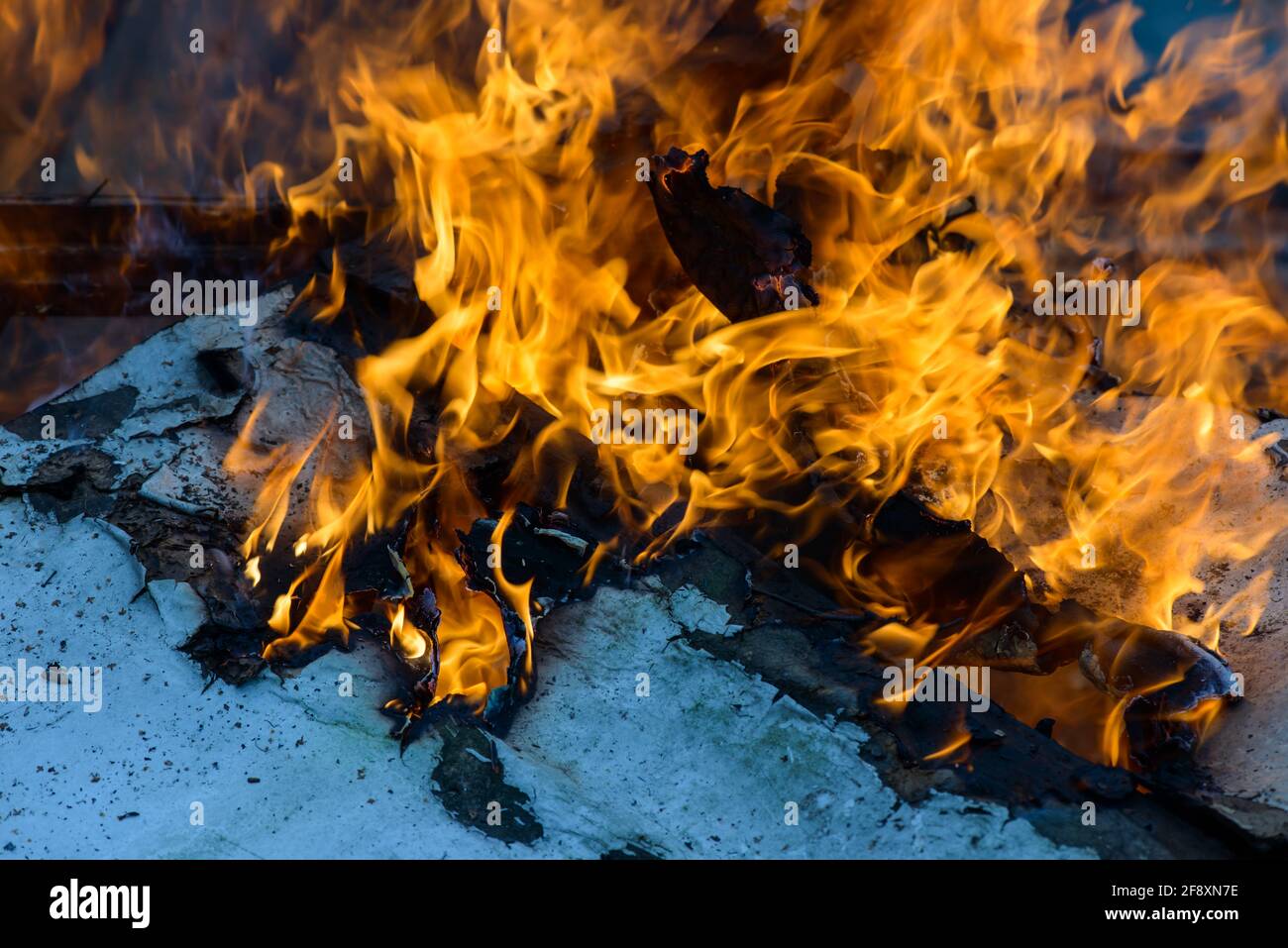 Spurts of flame. Burning wooden boards and logs. The bright flame of ...