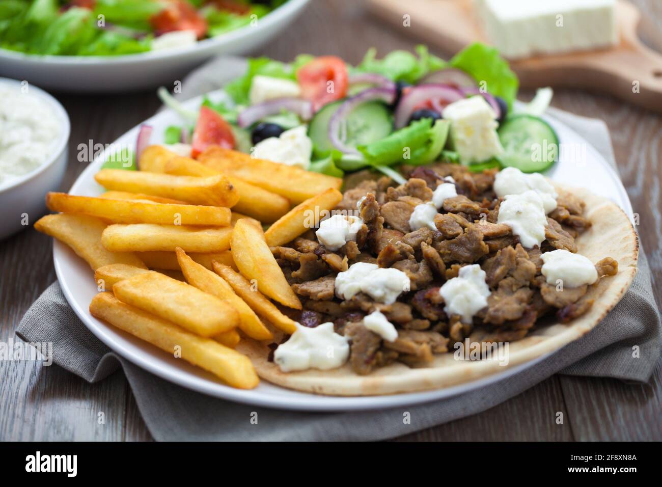 Greek Gyros with Fries and Salad on a Plate Stock Photo - Alamy