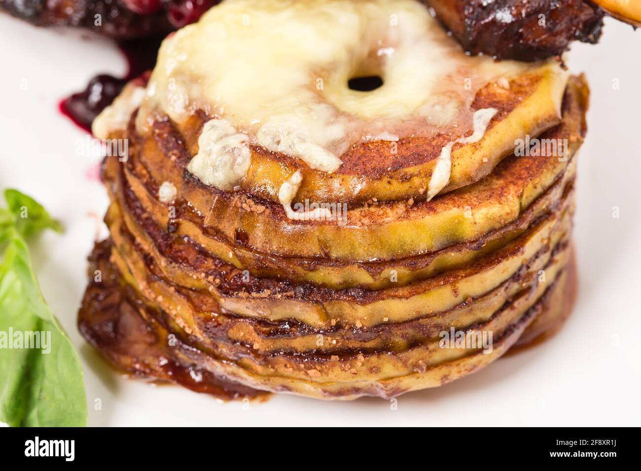 Delicious baked apple with cheese as a garnish for duck leg confit ...