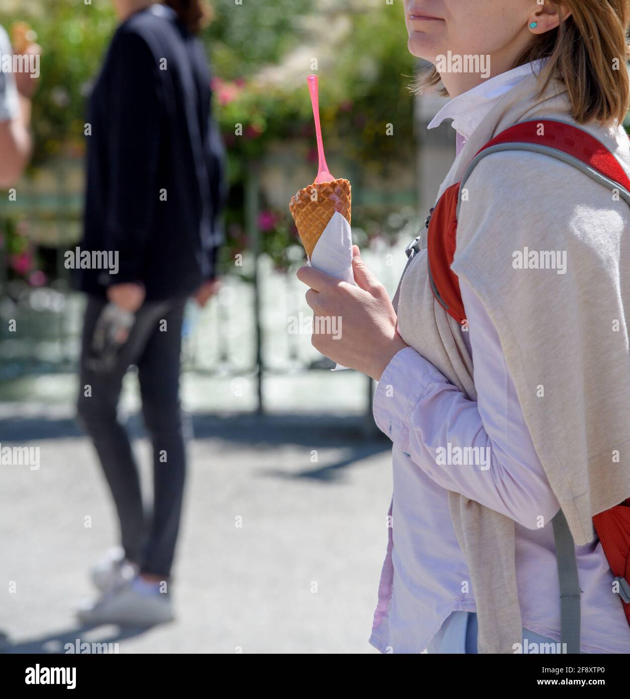 Side view of young tourist woman holding ice-cream cone Stock Photo - Alamy