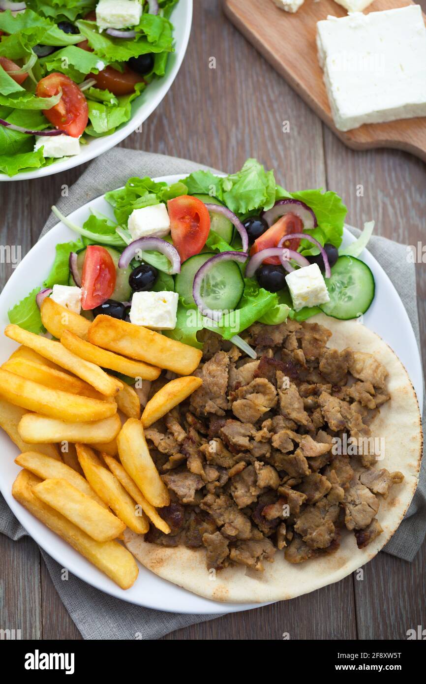 Greek Gyros with Fries and Salad on a Plate Stock Photo - Alamy
