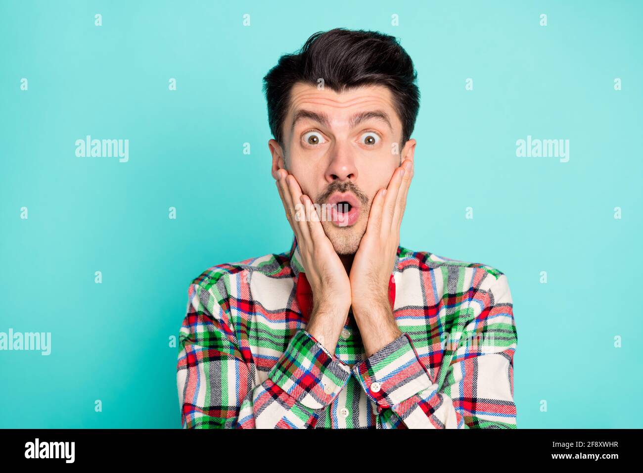 Photo of mad speechless guy look camera palms cheeks open mouth wear ...