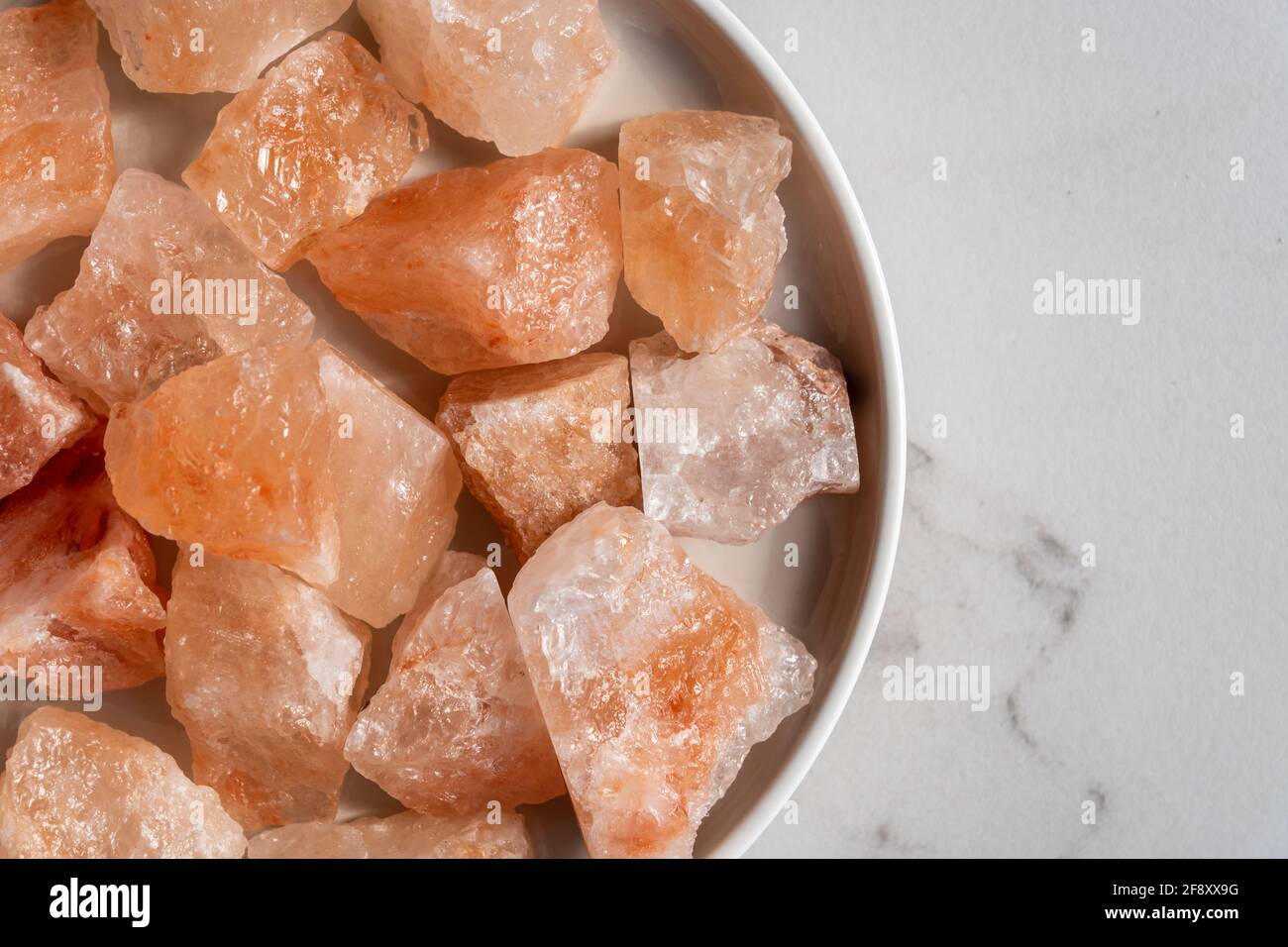 Organic Himalayan mineral salt crystals on round ceramic tray. Interior ...
