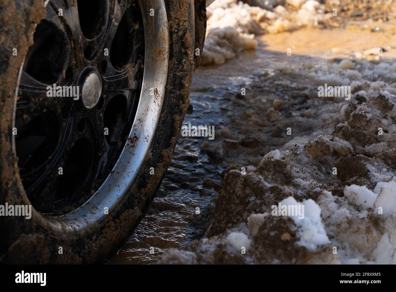 Car wheel in mud and snow Stock Photo - Alamy