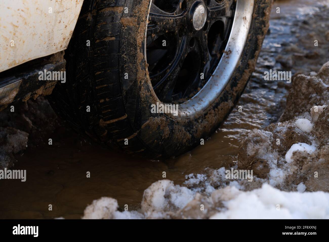 Car wheel in mud and snow Stock Photo - Alamy