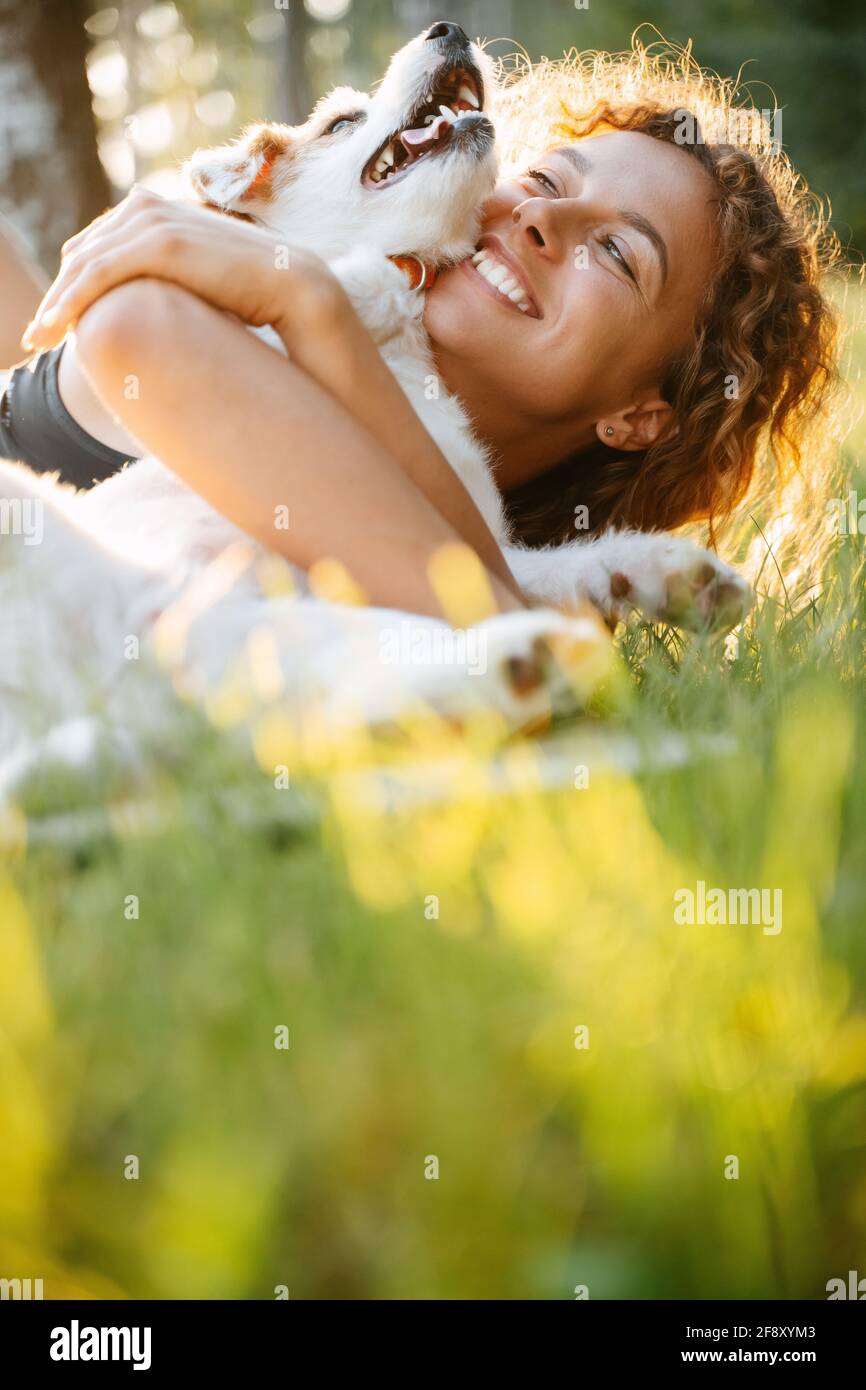 Happy owner hugs the dog jack russell Stock Photo - Alamy