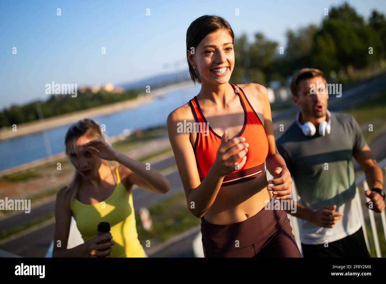 Friends fitness training together outdoors living active healthy Stock ...