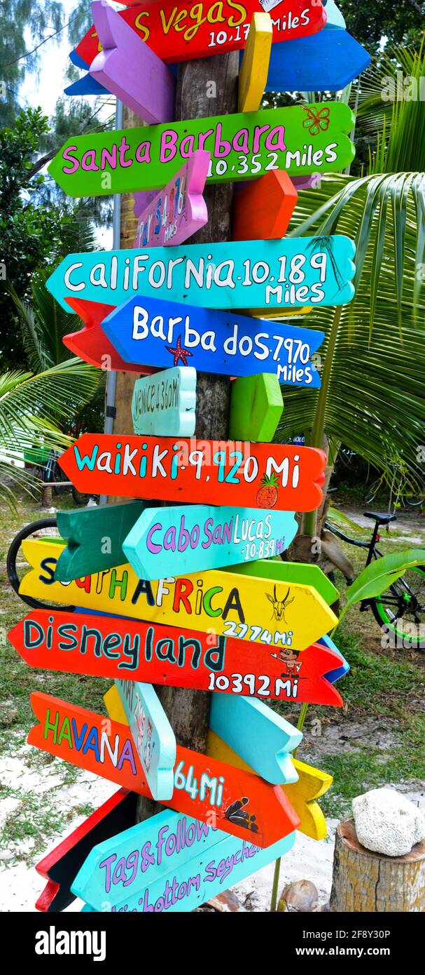 Directional signs at beach kiosk, Seychelles Stock Photo - Alamy