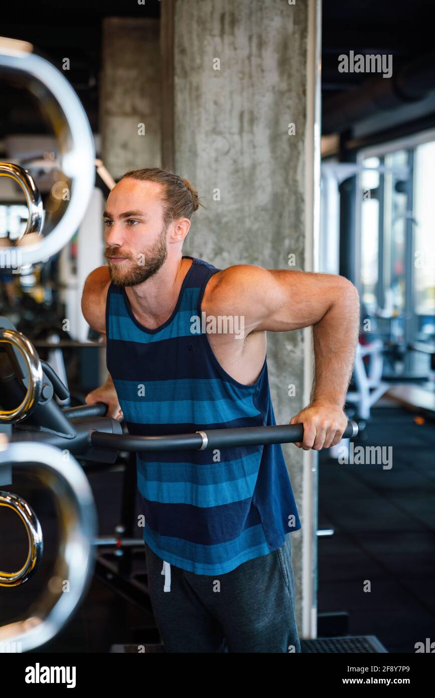 Muscular man working out in gym doing exercises to stay healthy Stock ...