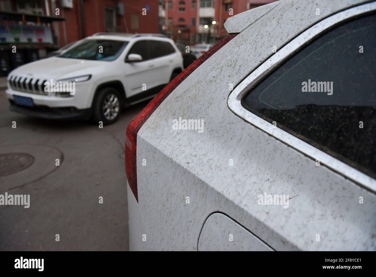 A car seen parked while covered with dust. In Beijing, dust, gale and ...