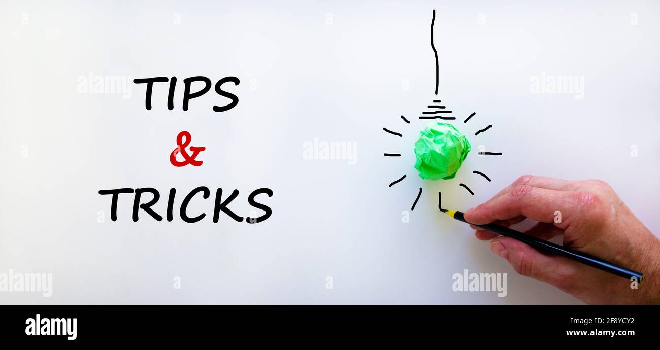 Tips and tricks symbol. Businessman writing words 'Tips and tricks ...