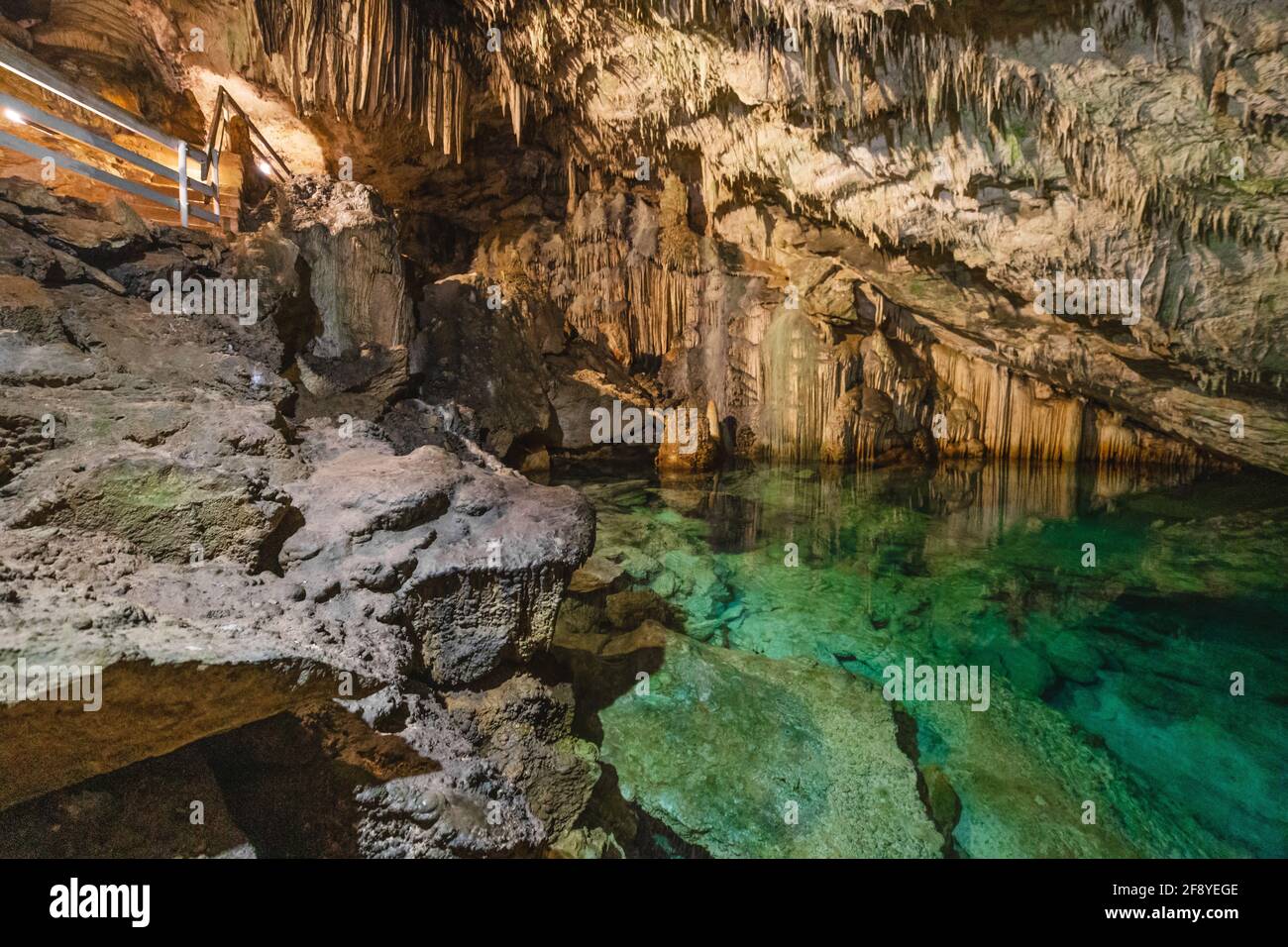 Cavern with turquoise calm water inside and stone walls Stock Photo - Alamy