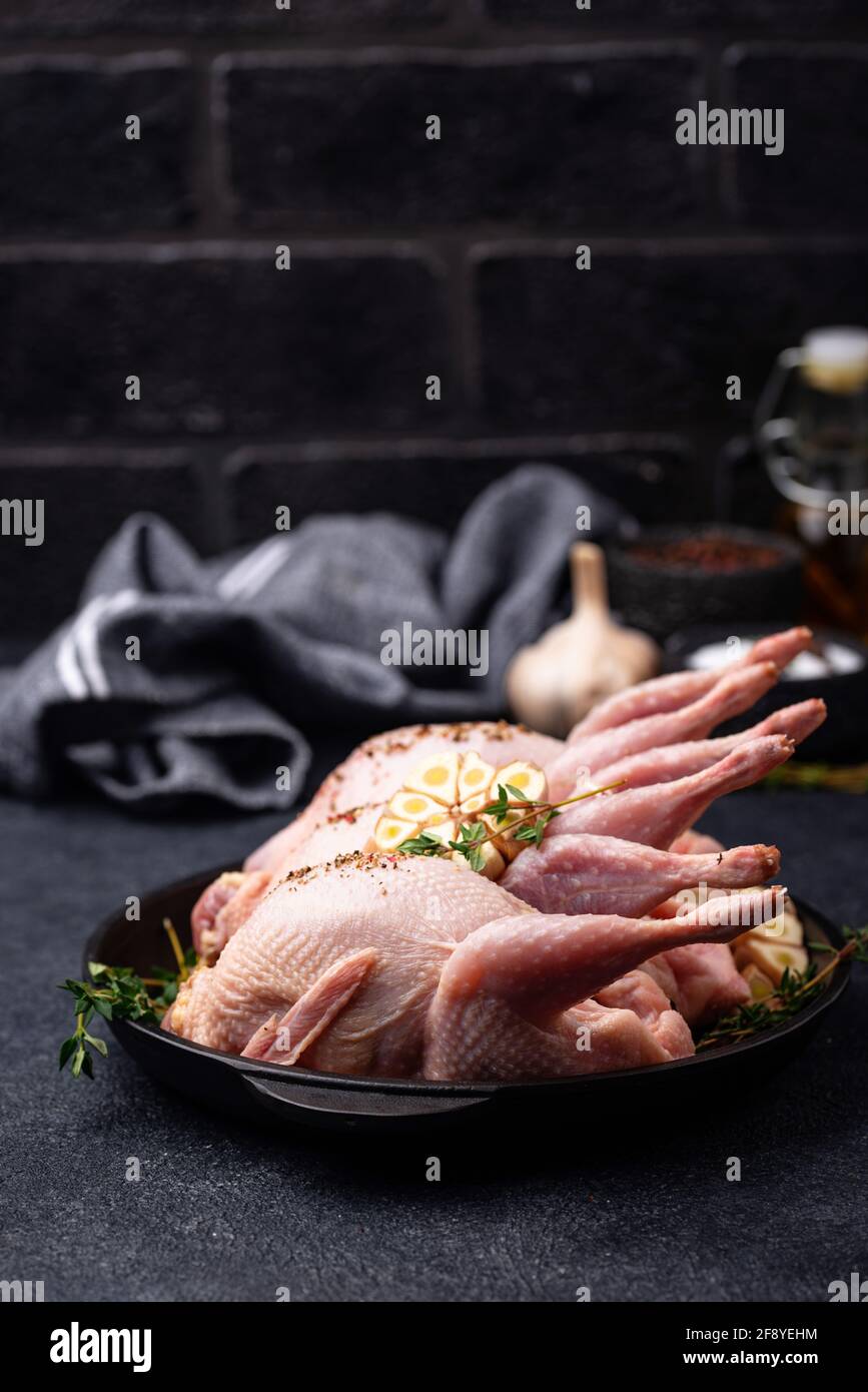 Raw quail meat with spices, garlic and herbs Stock Photo - Alamy