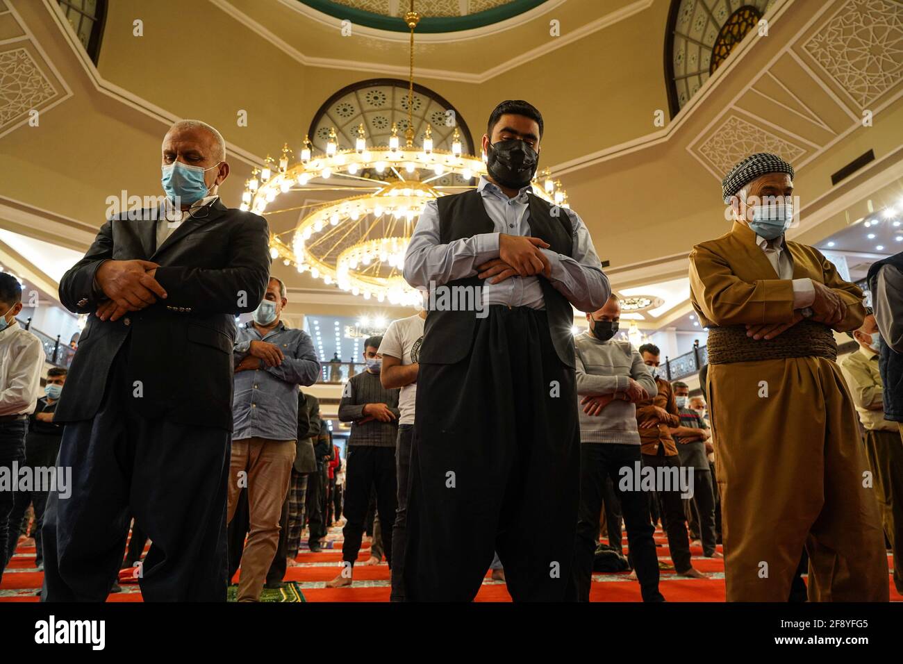 Iraqi Kurdish people maintain social distance as they offer Tarawih ...