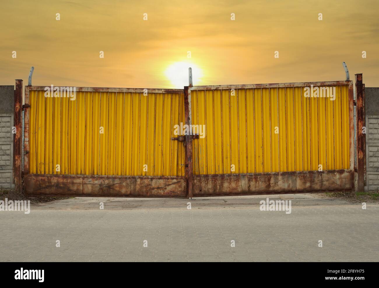 Yellow old metal gate with sunset background. Vintage style Stock Photo ...