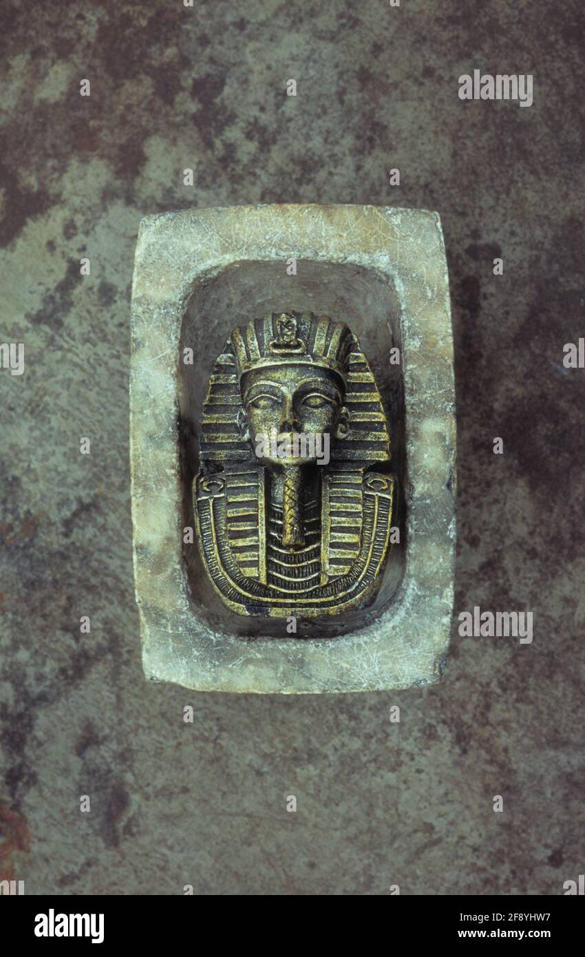 Tarnished brass model of bust of Pharaoh Tutankhamen in grey marble ...