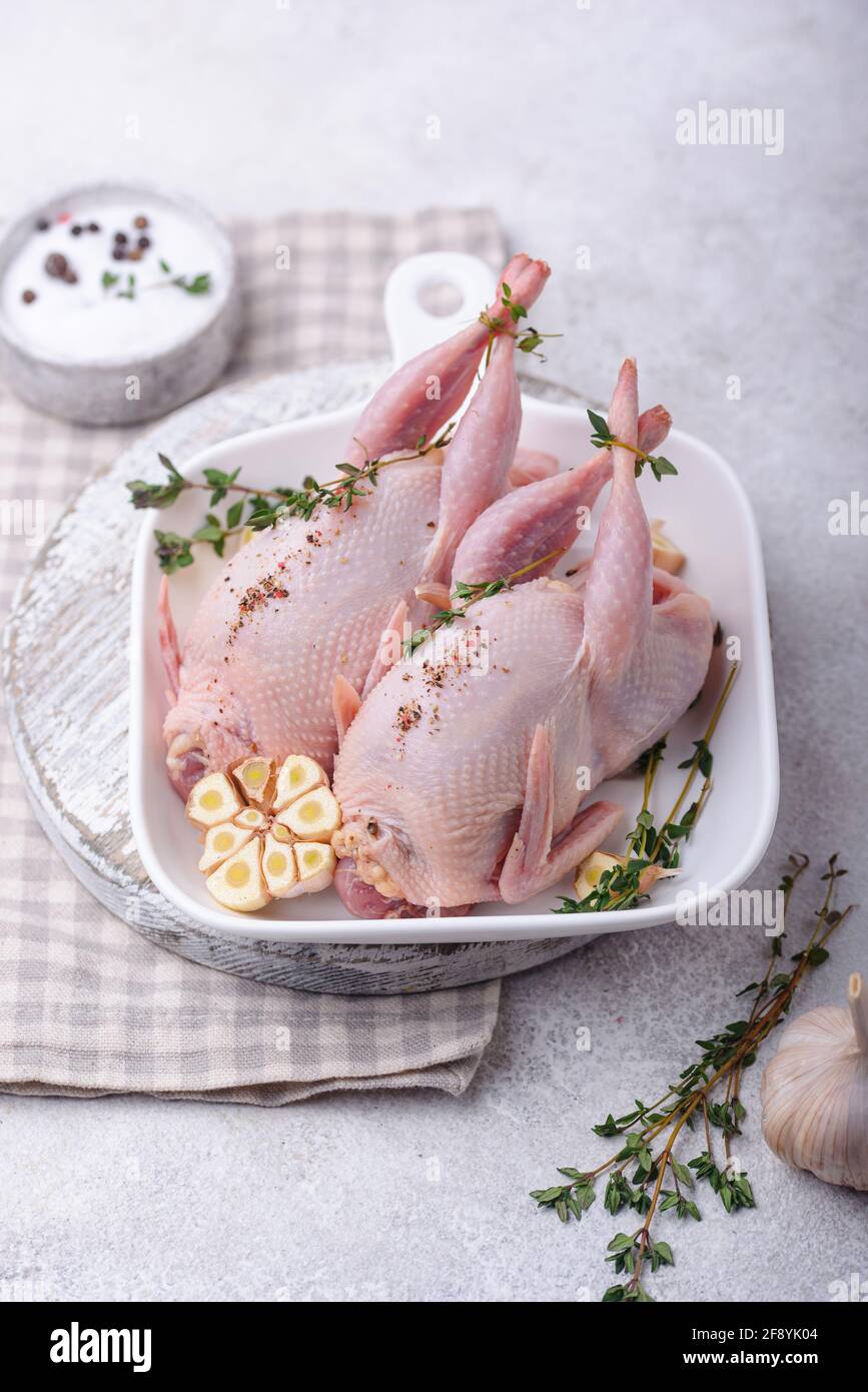 Raw quail meat with spices, garlic and herbs Stock Photo - Alamy