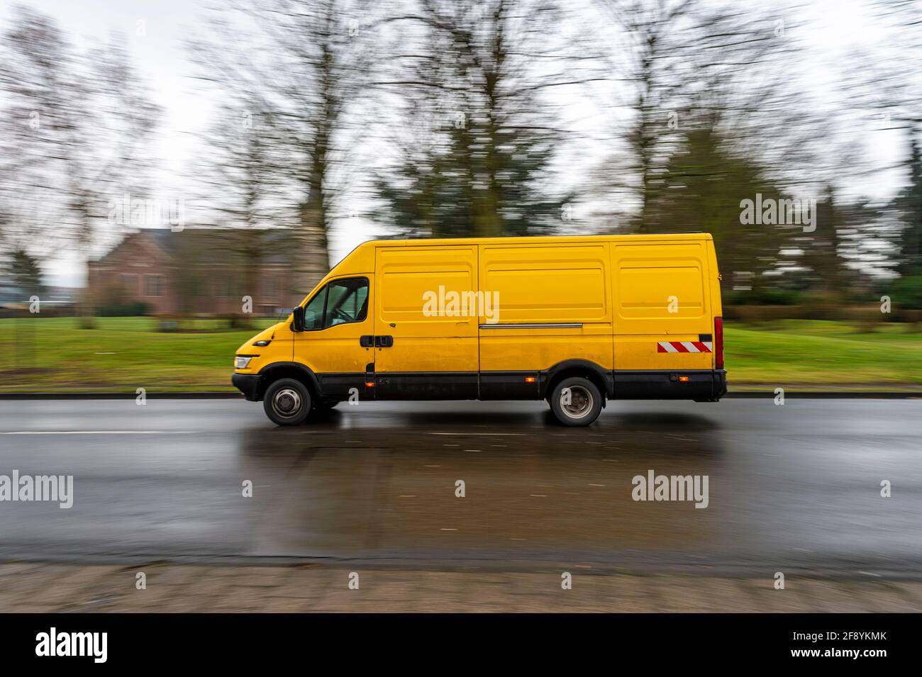 Yellow Transporter Driving Fast Stock Photo - Alamy
