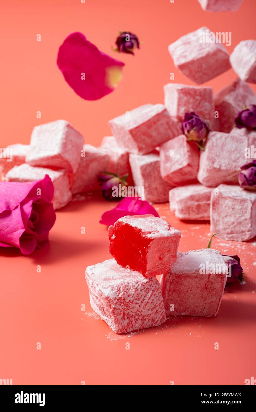 Levitating rose flavoured pink Turkish delight with flower petals and ...