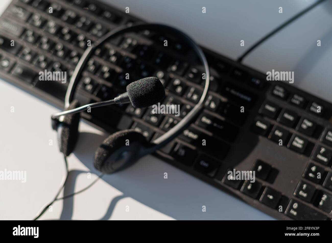 Headset with microphone on the computer keyboard. Call center operator ...
