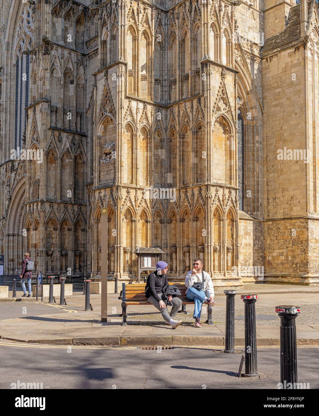 The forecourt of York Minster in a Spring sunshine. Two young men in ...