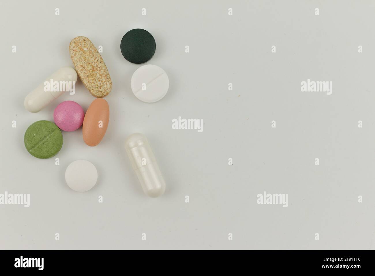 Different colorful pills on white background Stock Photo - Alamy