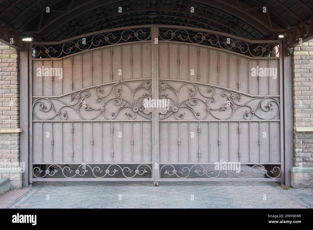 Gray iron gates with decorative elements Stock Photo - Alamy