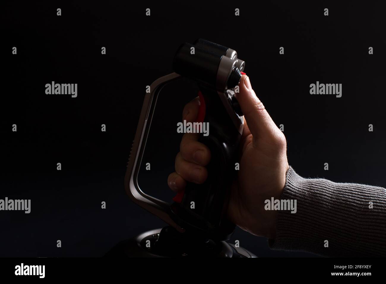 Male hand holding aircraft controller with finger on a trigger, on ...