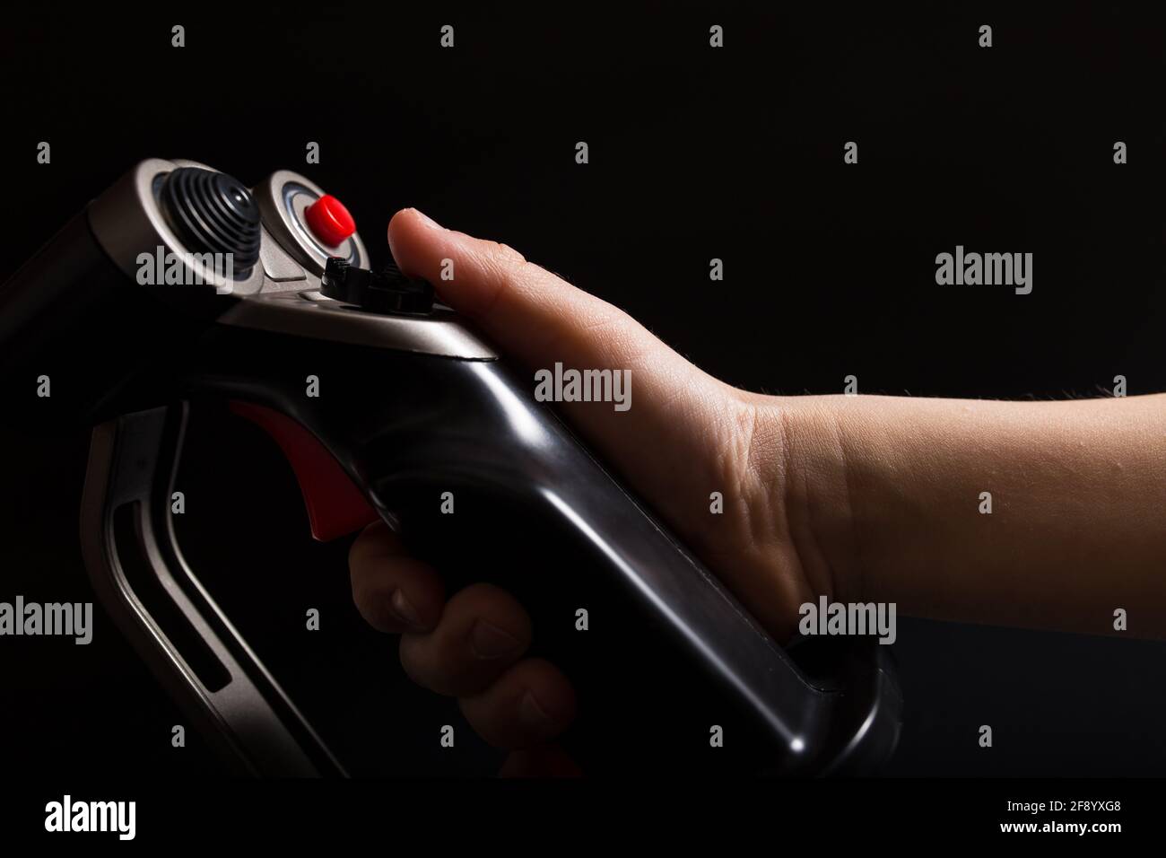 Child's hand playing with joystick aircraft simulator, close up on ...