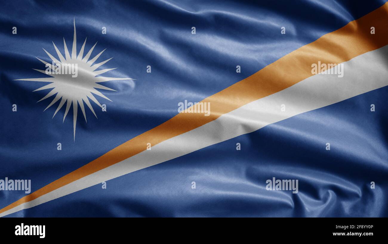 Marshallese flag waving in the wind. Close up of Marshall banner ...