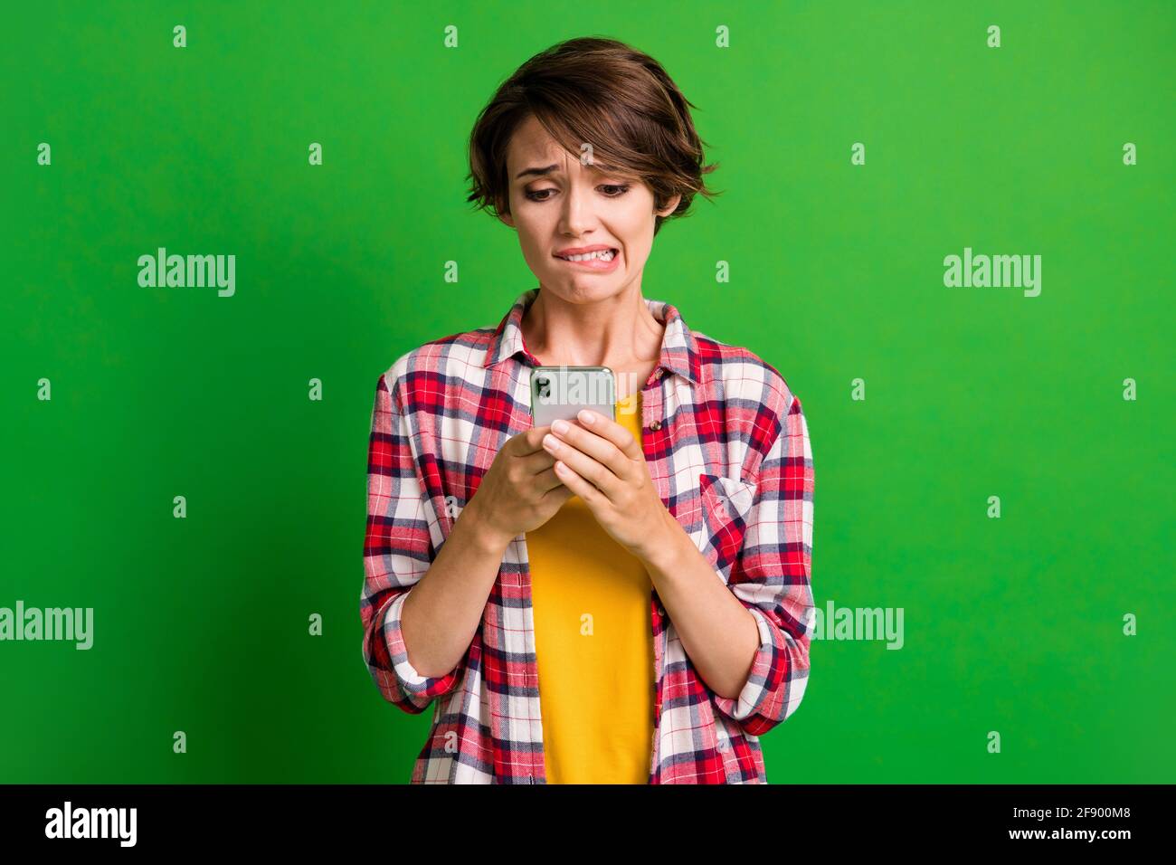 Photo of worried person bite lip look screen oops mistake plaid ...