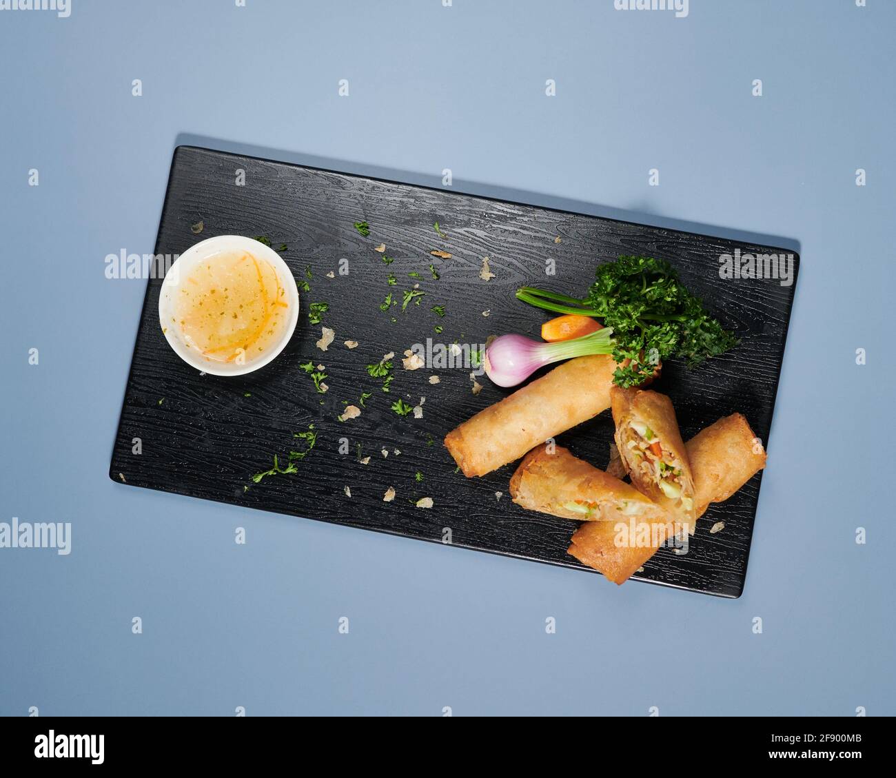 Top view of fried veggie rolls with sauce served on a black plate Stock ...