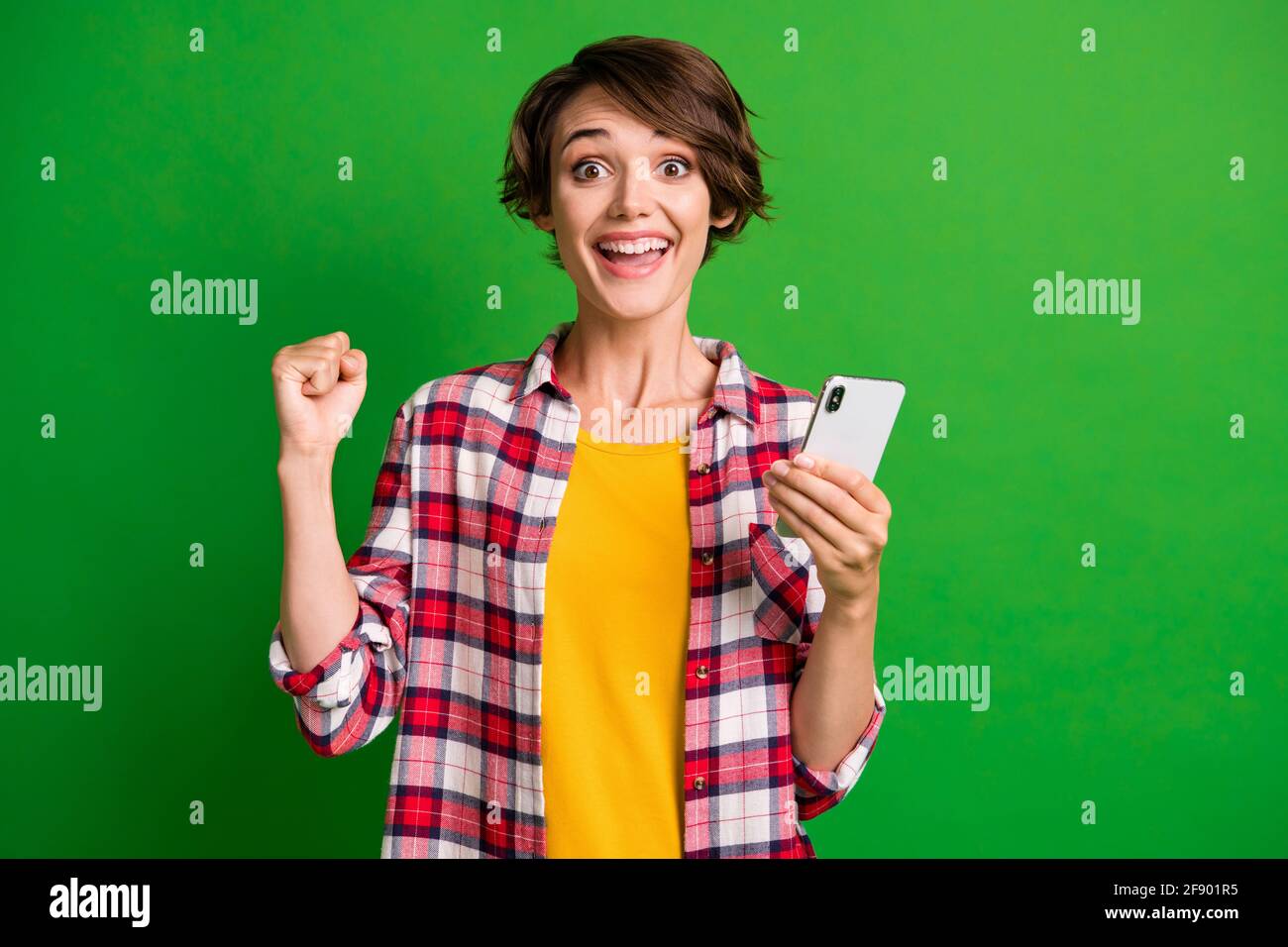 Photo of positive person fist up success subscribe hold gadget plaid ...