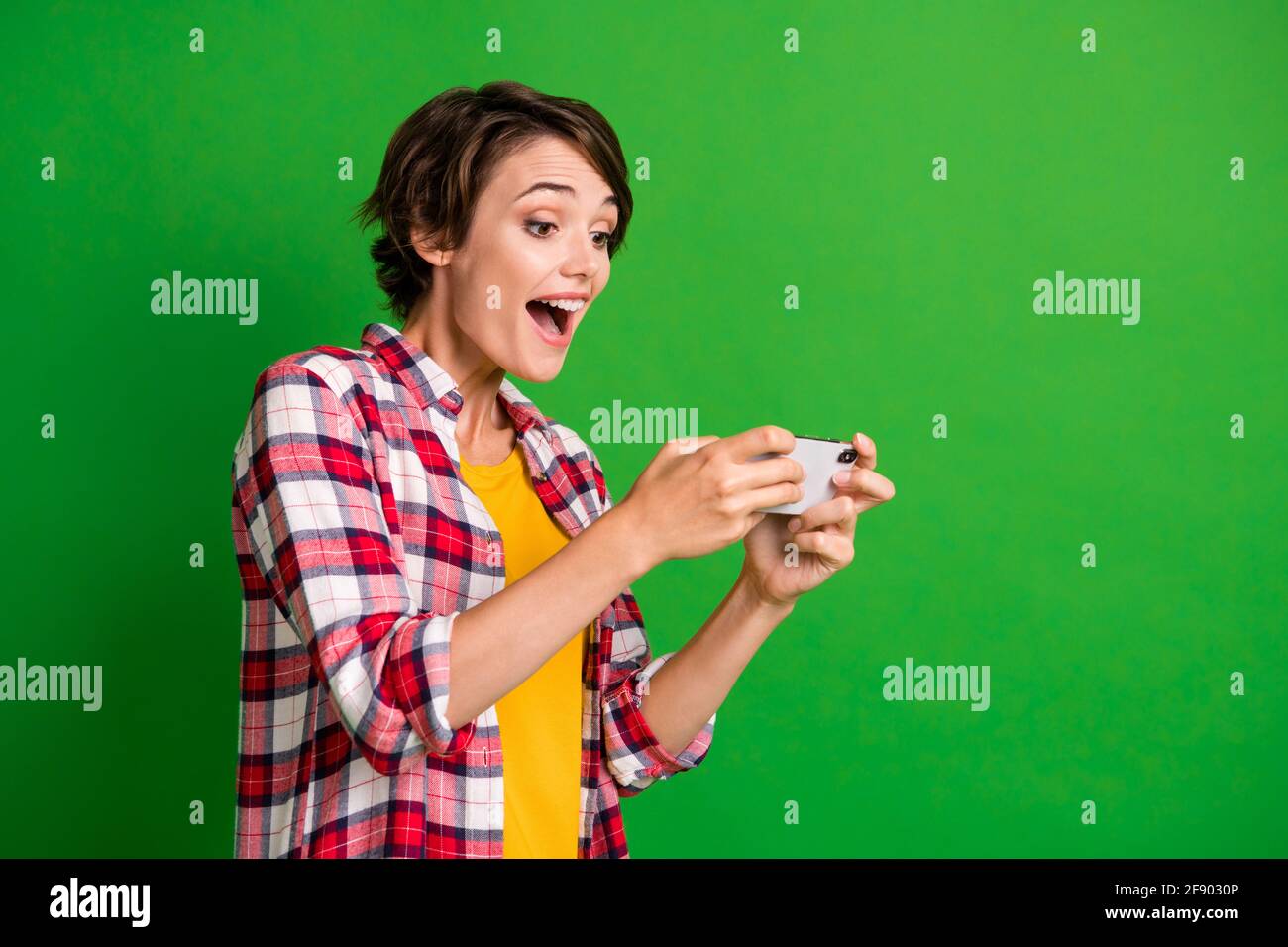 Portrait of astonished cheerful person play game open mouth good mood ...